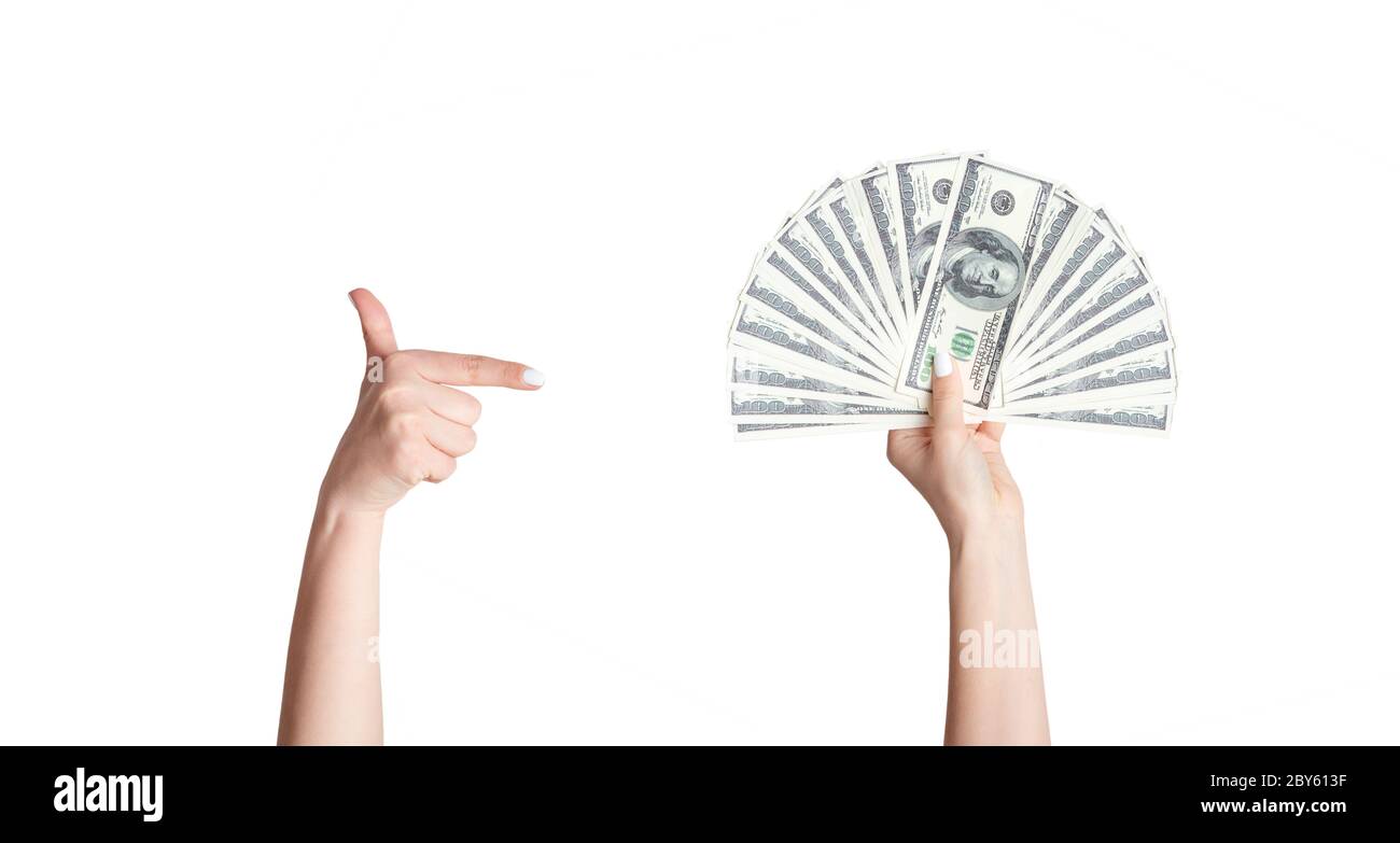 Financial success. Millennial woman pointing at fan of money in her ...