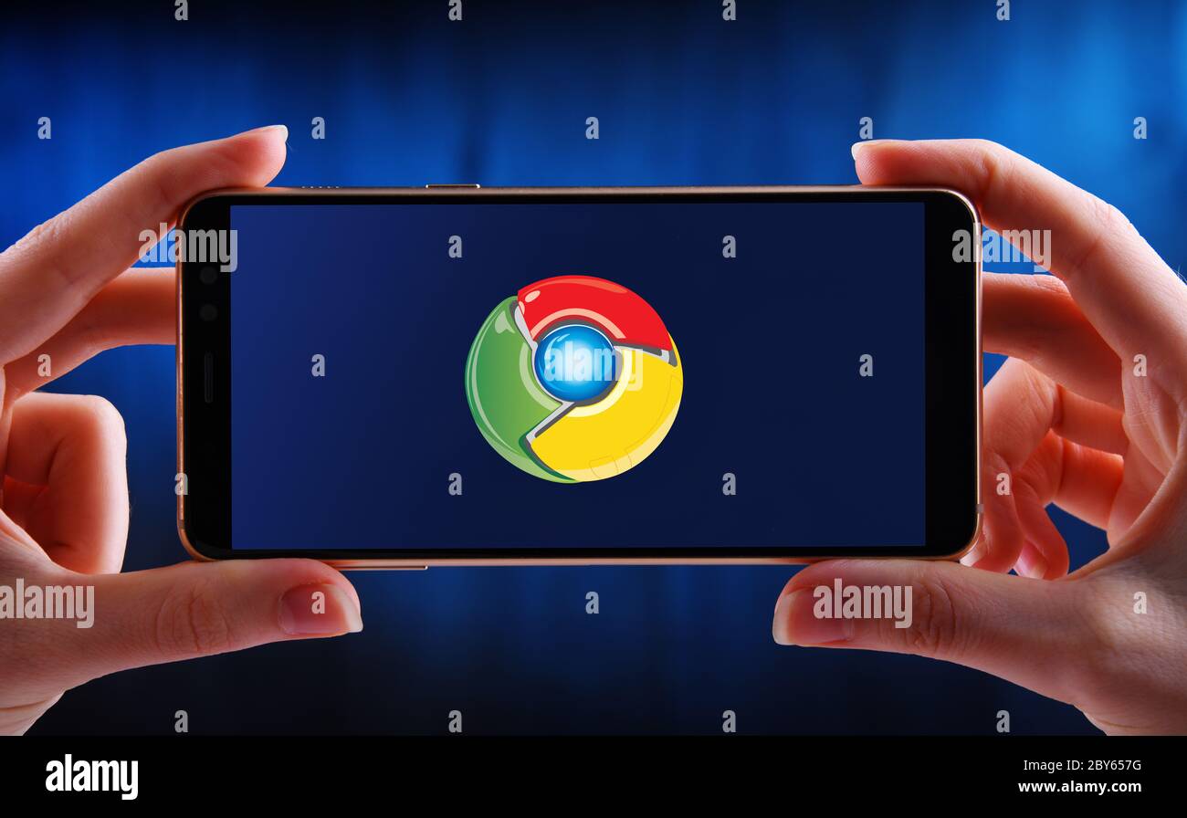 POZNAN, POL - MAY 21, 2020: Hands holding smartphone displaying logo of ...