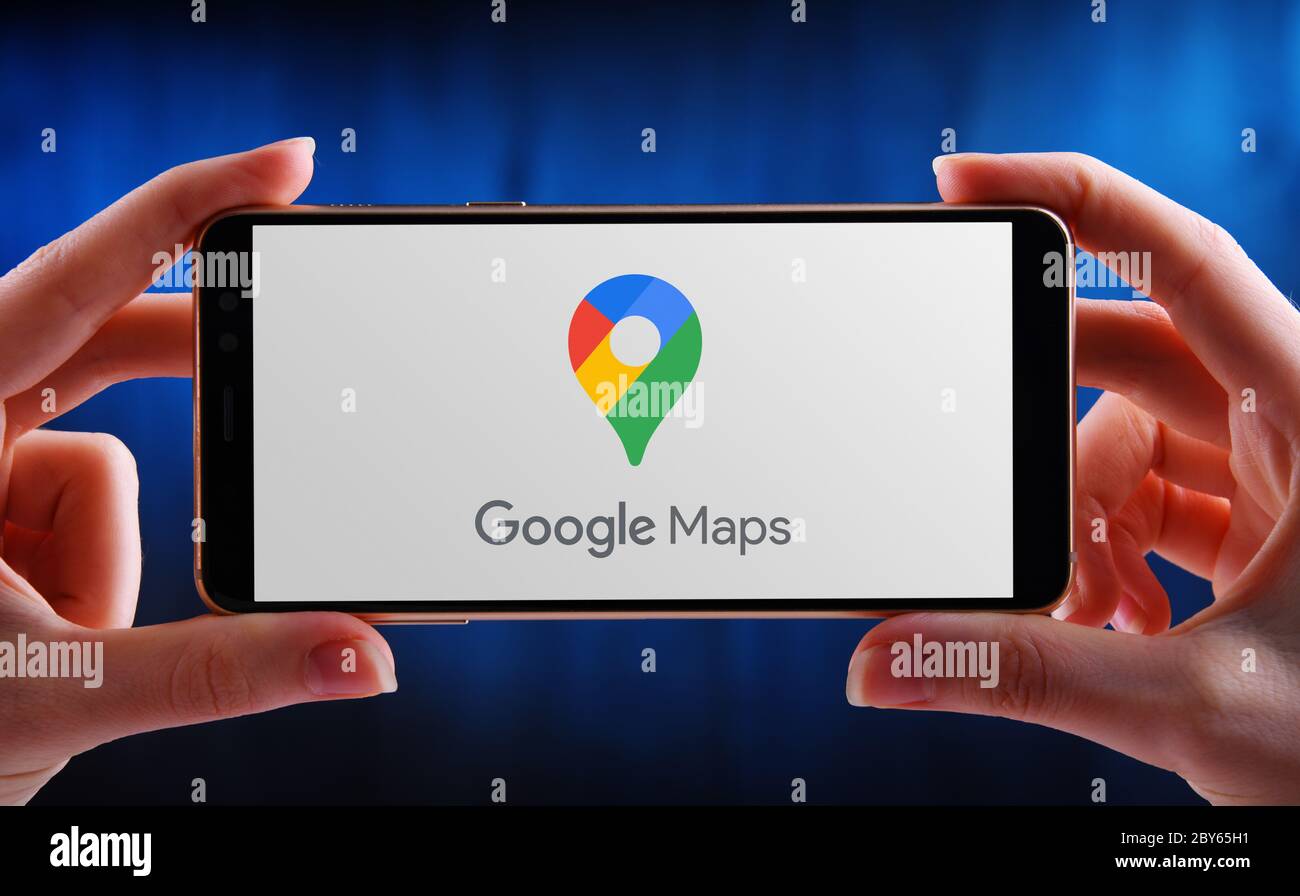 POZNAN, POL - MAY 21, 2020: Hands holding smartphone displaying logo of ...