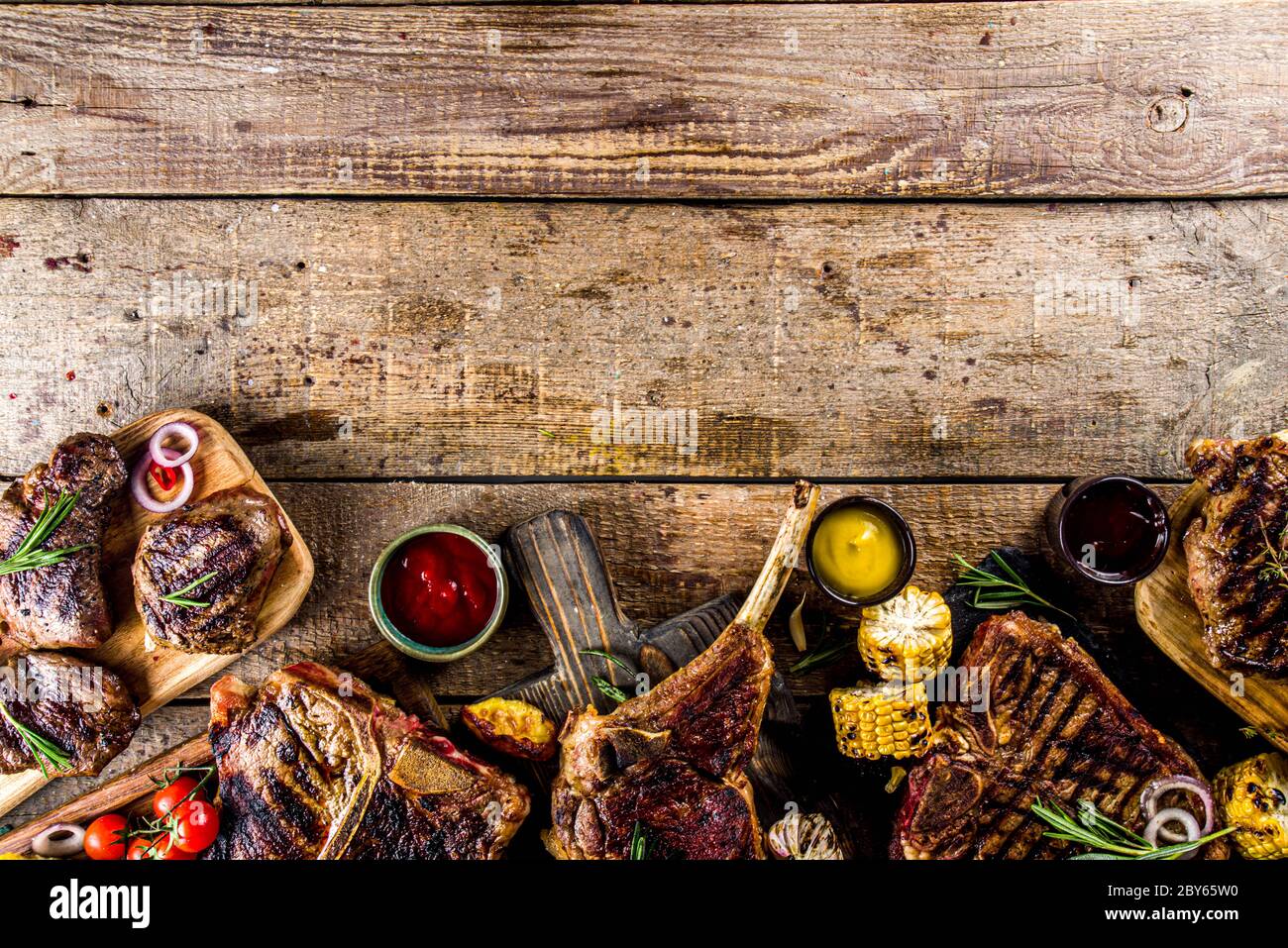 Set of various grilled meat, different beef steaks with sauces.Bbq beef ...