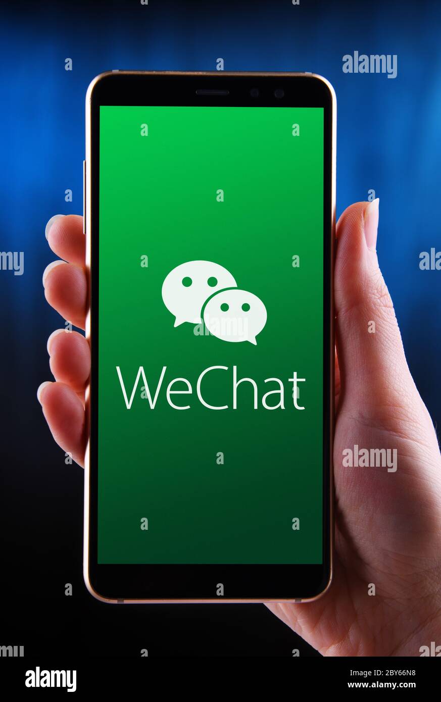 POZNAN, POL - MAY 21, 2020: Hands holding smartphone displaying logo of ...