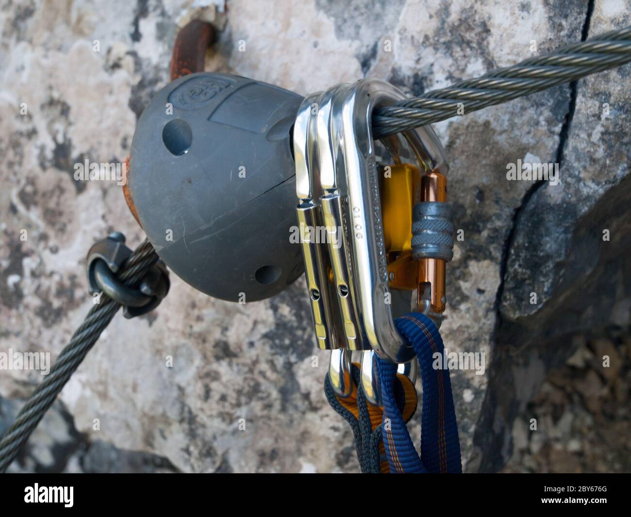 Snap-hooks on the metal rope, climbing equipment for ferrata, detailed ...