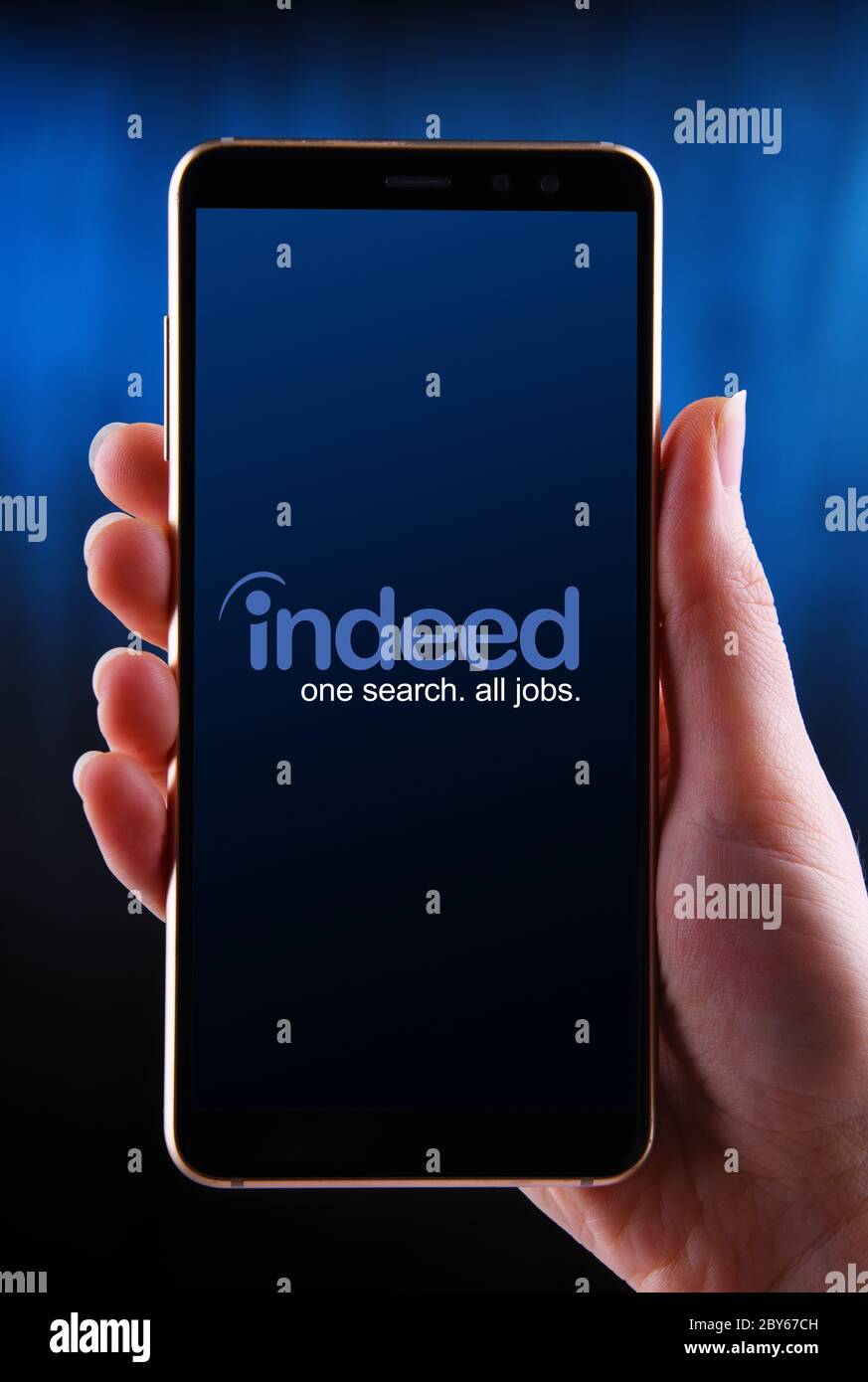 POZNAN, POL - MAY 21, 2020: Hands holding smartphone displaying logo of ...