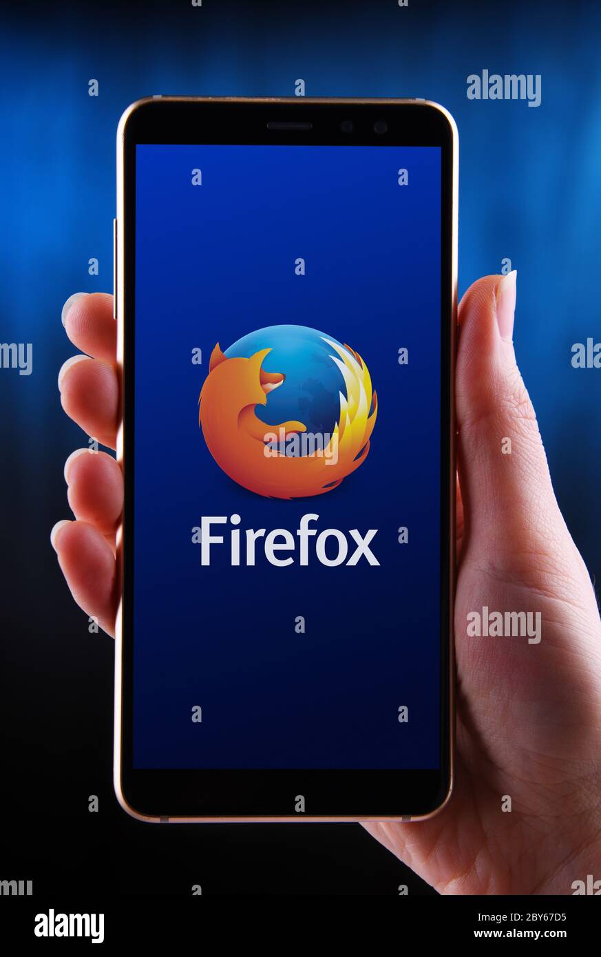 POZNAN, POL - MAY 21, 2020: Hands holding smartphone displaying logo of ...
