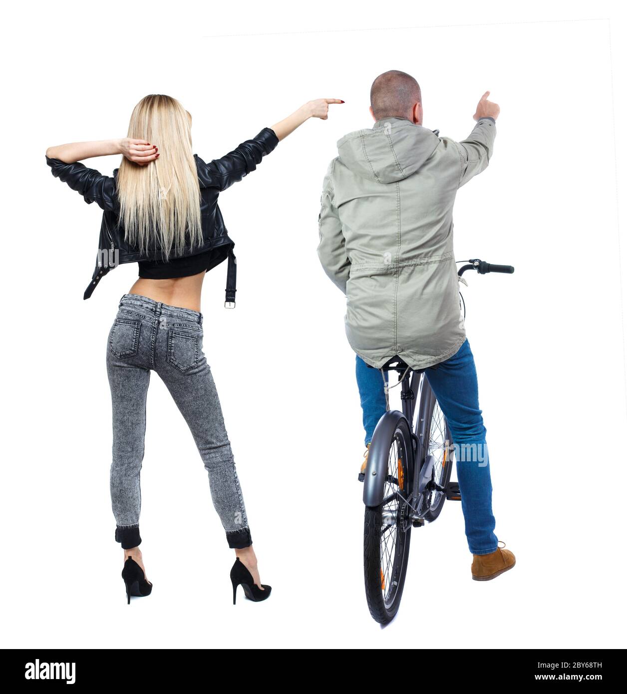 Back view of couple in winter jacket. man on a bicycle and a woman ...