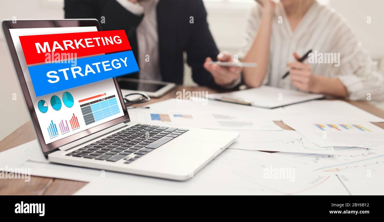Business strategy written on laptop, people discussing plan Stock Photo ...