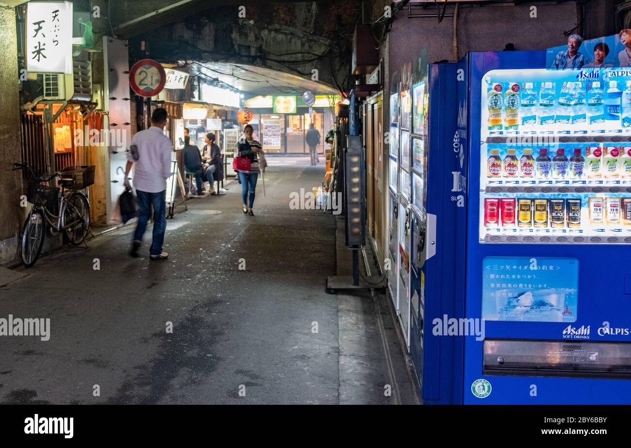 People walking at Yurakucho district back alley, Tokyo, Japan at night ...