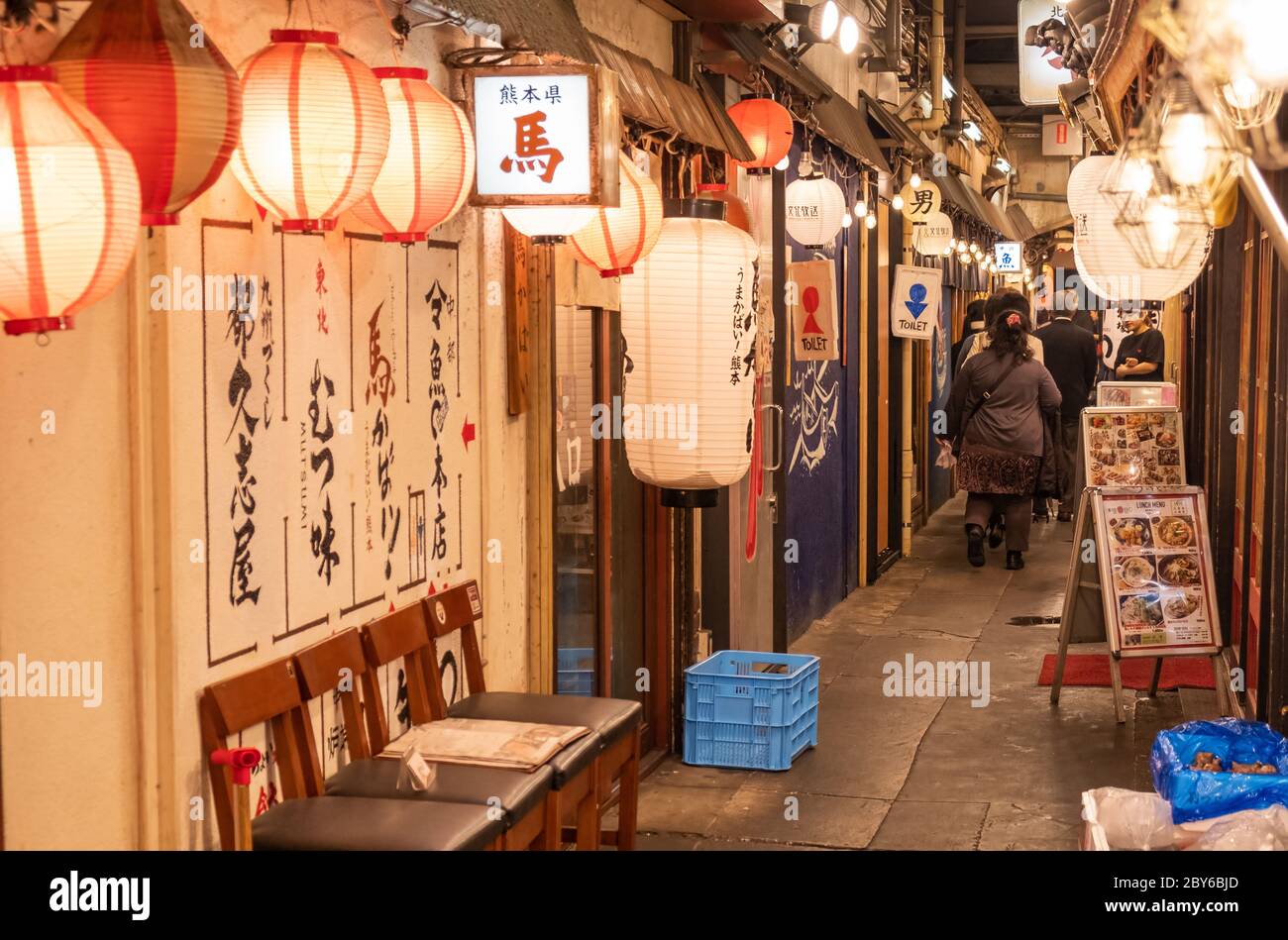 People walking at Yurakucho district back alley, Tokyo, Japan at night ...