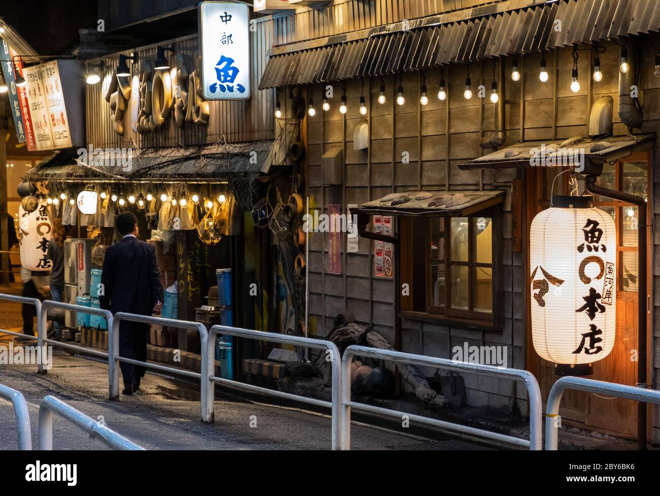 People walking at Yurakucho district back alley, Tokyo, Japan at night ...