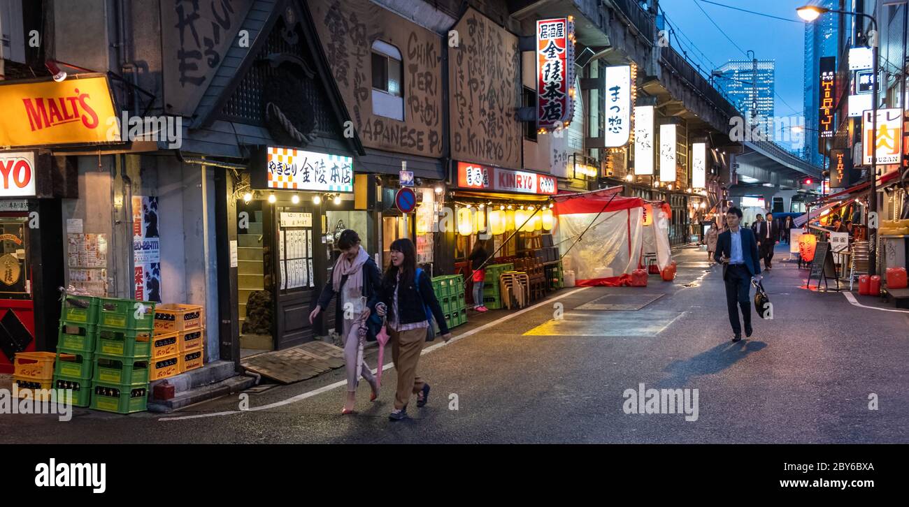 People walking at Yurakucho district back alley, Tokyo, Japan at night ...
