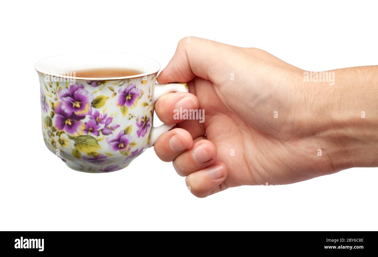 A cup of tea and a hand isolated on white background Stock Photo - Alamy