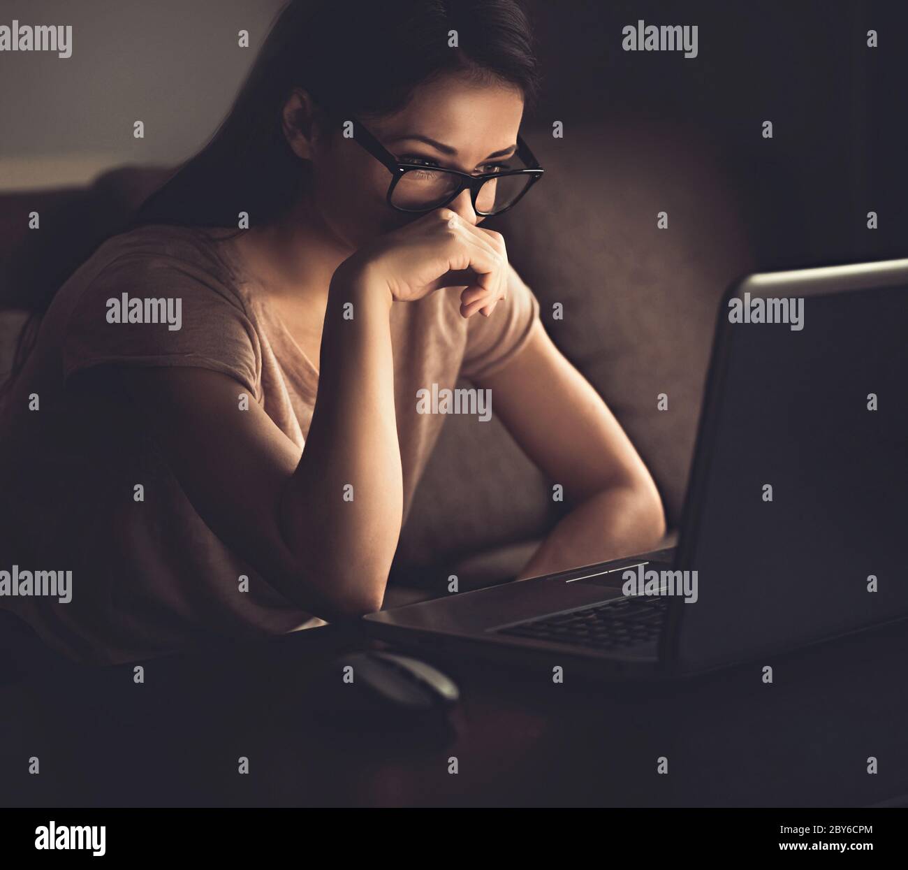 Smiling thinking young beautiful woman in eye glasses looking on ...