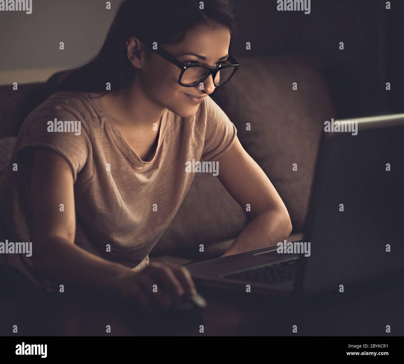 Smiling thinking young beautiful woman in eye glasses looking on ...