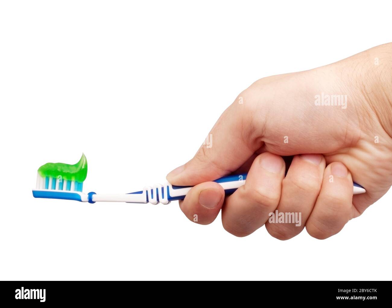 Toothbrush and toothpaste in a hand isolated on white background Stock ...
