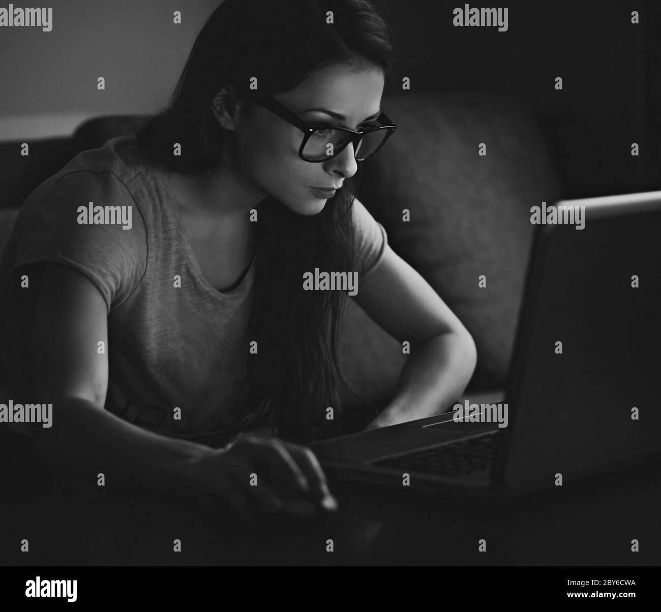 Serious thinking young beautiful woman in eye glasses looking on ...