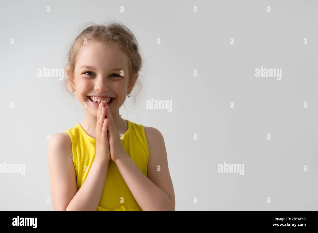 Girl folding hands hi-res stock photography and images - Alamy
