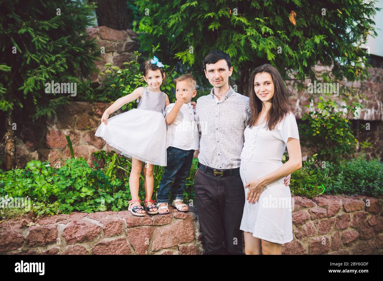 Family portrait of a big friendly family. Caucasian pregnant mom dad ...