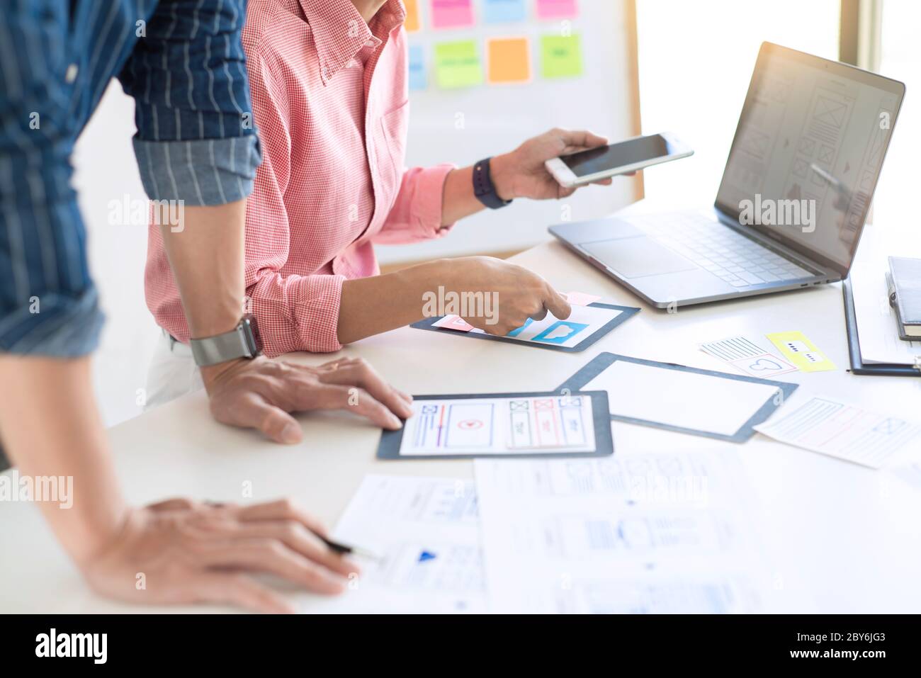 Graphic designers team work together with UX UI designer planning ...