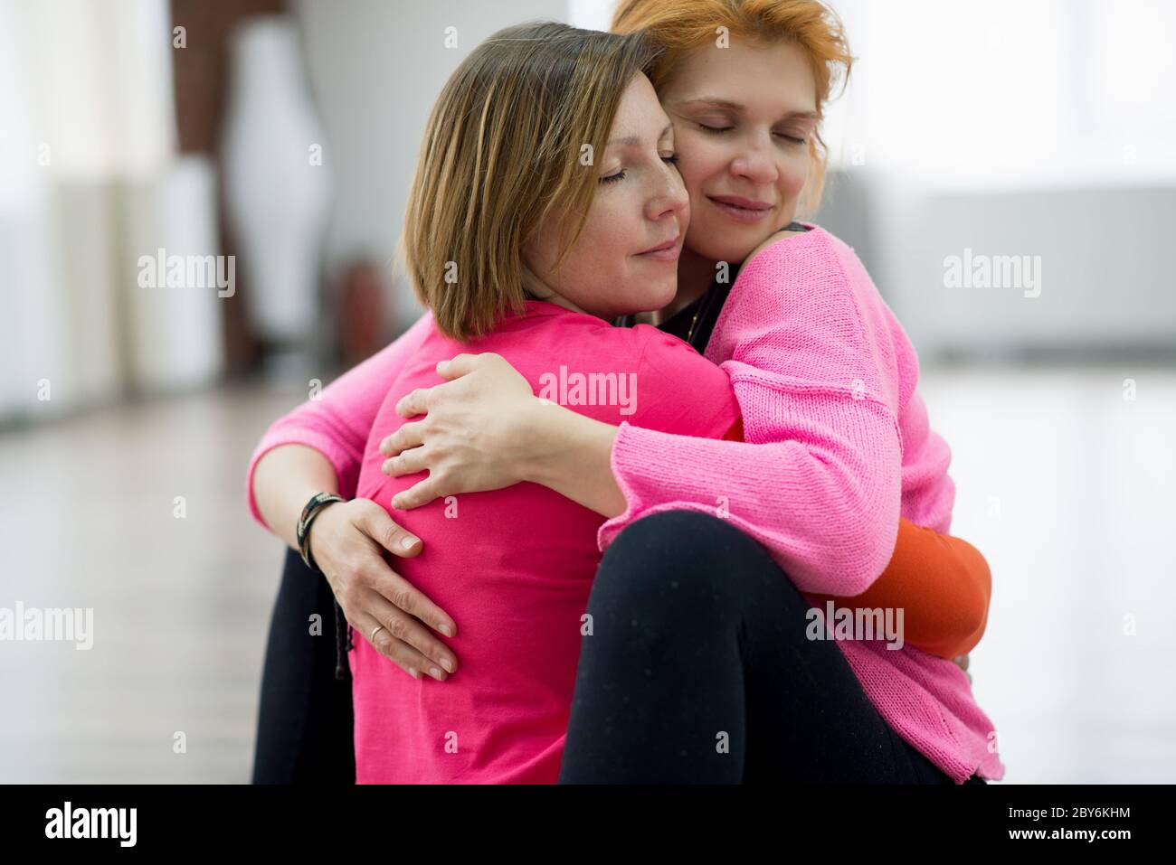 Two women are hugging Stock Photo - Alamy