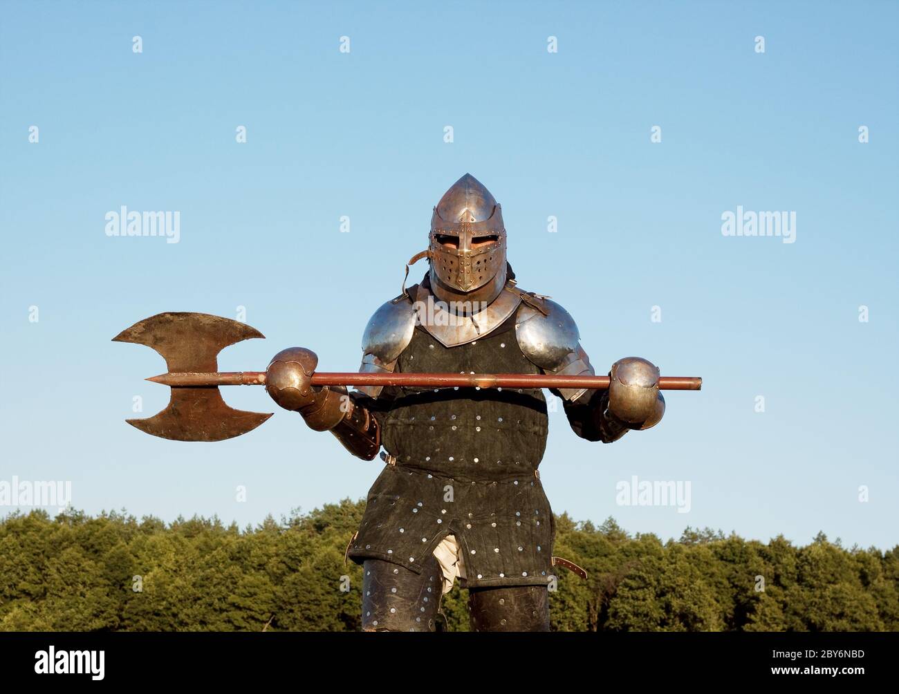 Medieval knight in the field with an axe Stock Photo - Alamy
