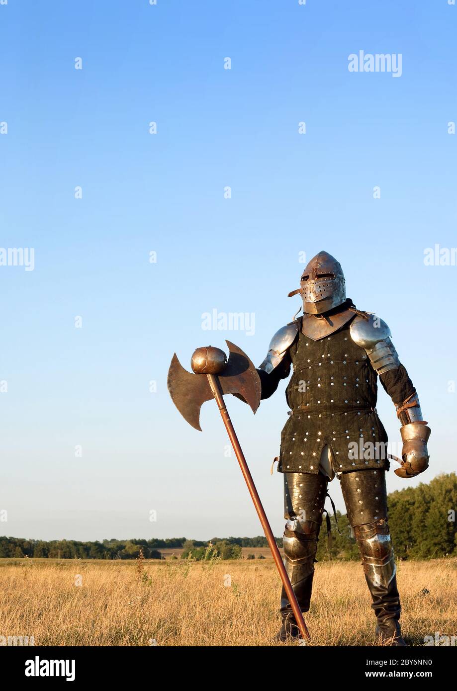 Medieval knight in the field with an axe Stock Photo - Alamy