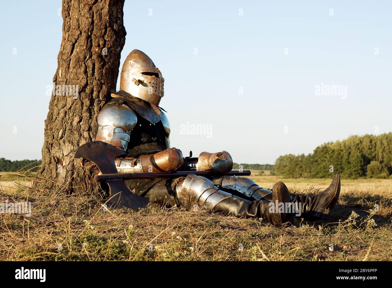Medieval knight in the field with an axe Stock Photo - Alamy
