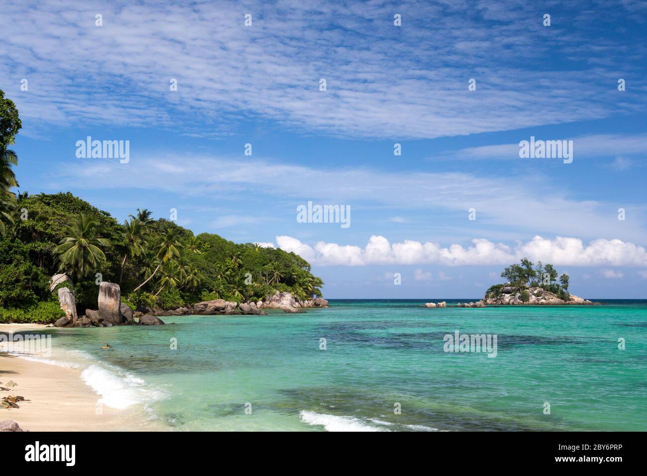 Beautiful beach with a small island in the near, Seychelles Stock Photo ...