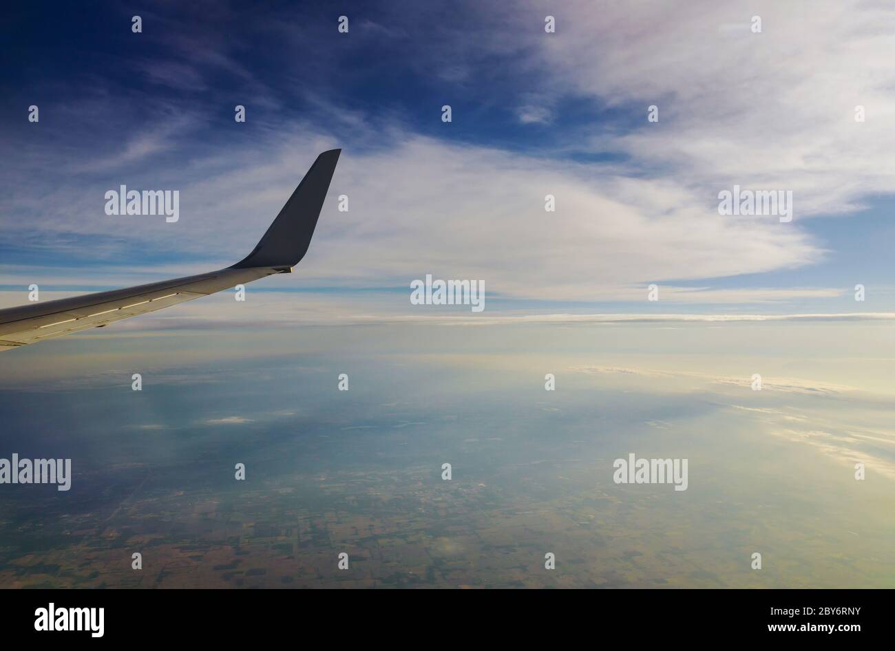 Airplane flying above clouds an aircraft wing on blue sky background ...