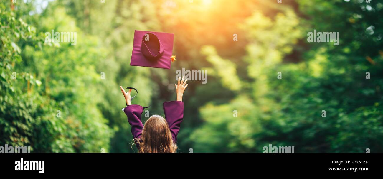 Photo from back graduate graduated little girl in cap throw it up in ...