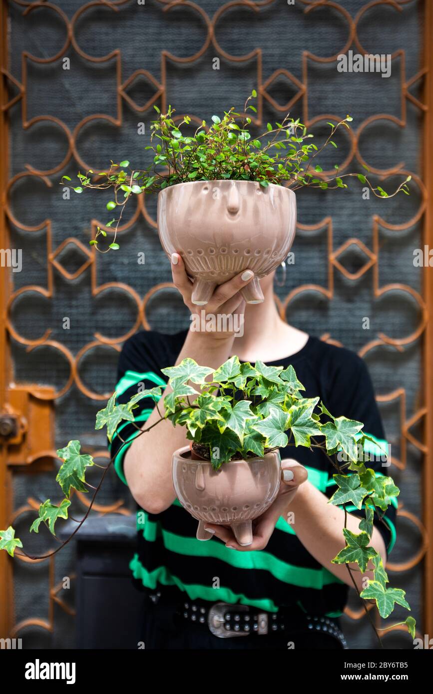 Woman holds pot home hi-res stock photography and images - Alamy