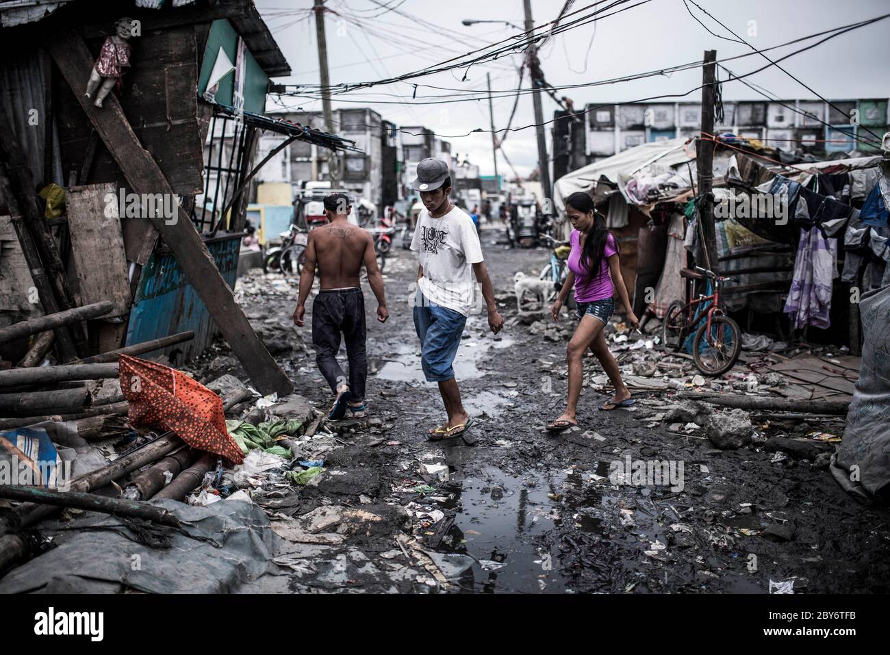 Residents walk buy Navotas cemetery in Manila, Philippines. In Manila ...