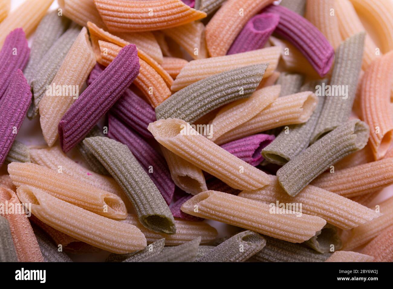 Tri-color penne pasta. Tomato, spinach and wheat pastas. Multicolored ...