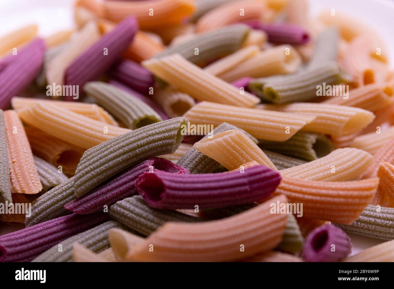 Tri-color penne pasta. Tomato, spinach and wheat pastas. Multicolored ...
