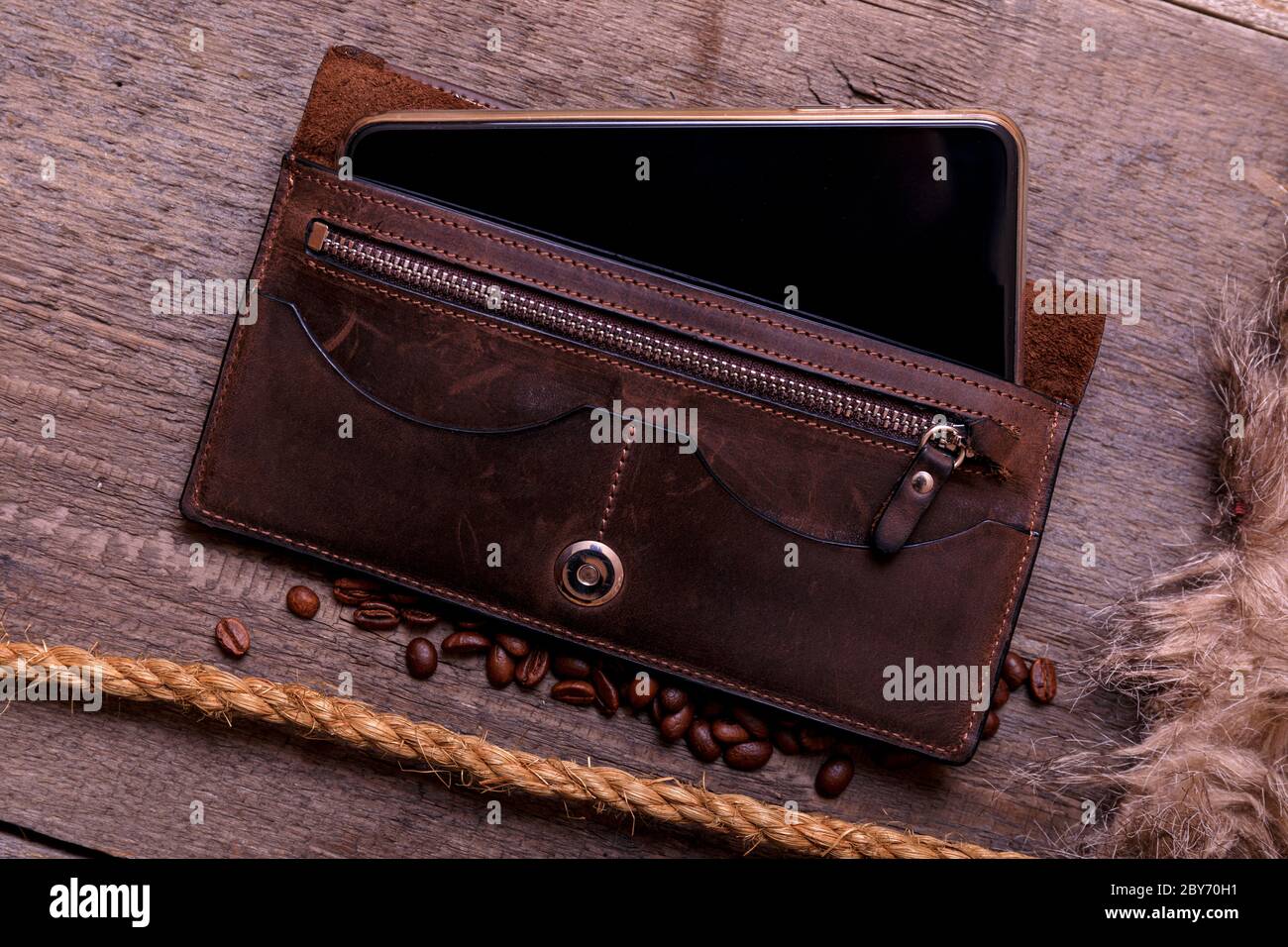 Still life photography of brown leather wallet, coffee beans, mobil ...