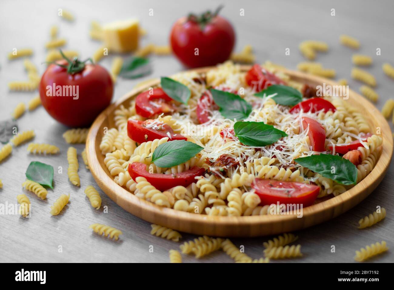 Summer cold pasta salad with fusilli pasta, fresh tomatoes, sun-dried ...