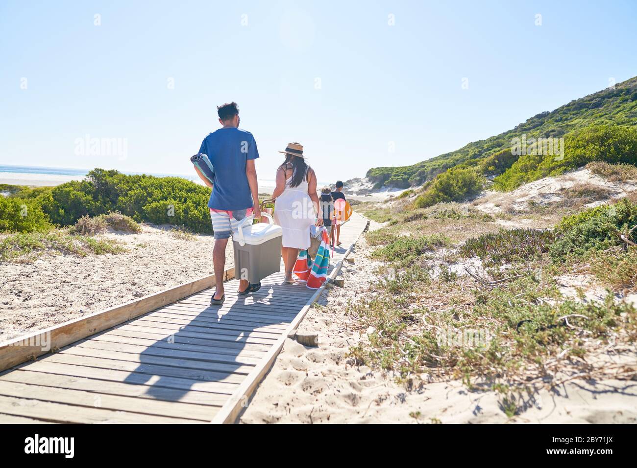 Mother carrying daughter on beach hi-res stock photography and images ...