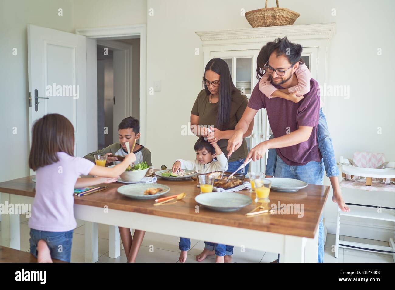 Family eating lunch at dining table Stock Photo - Alamy