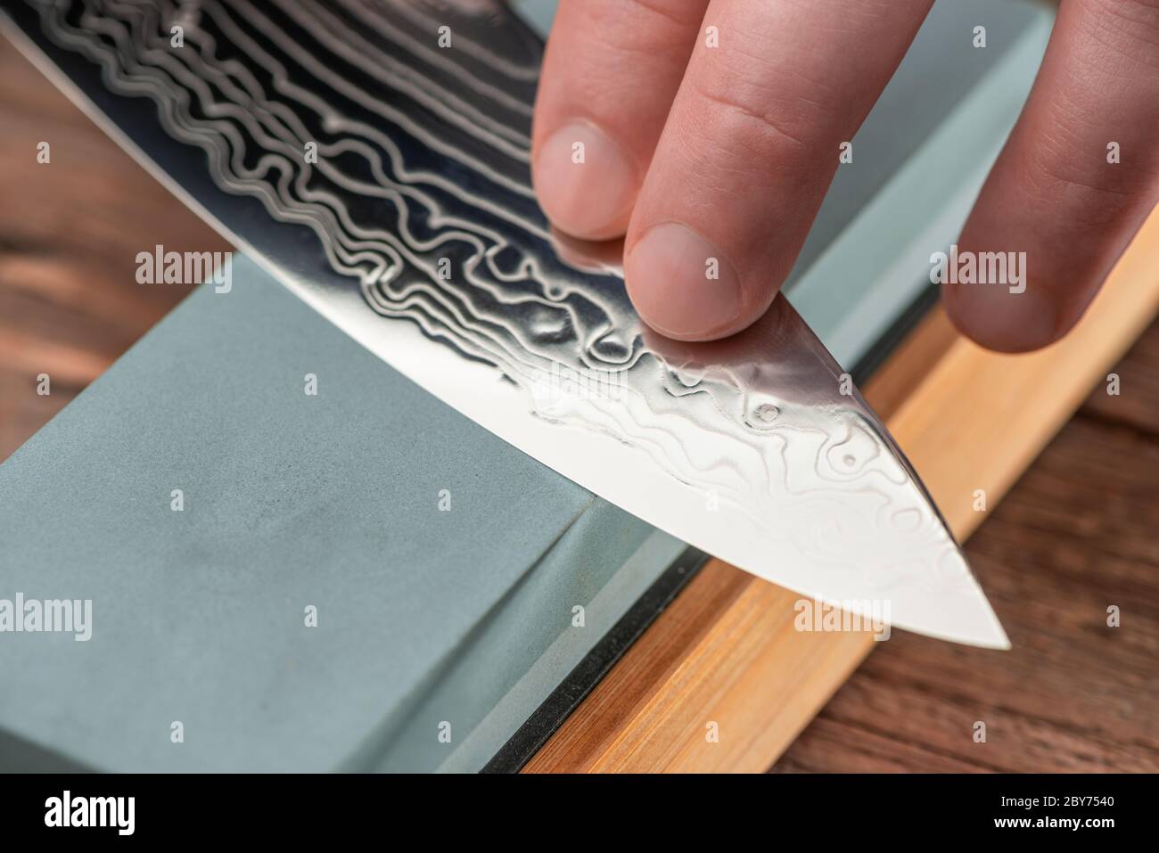 Close-up on a blade made of Damascus steel Stock Photo - Alamy