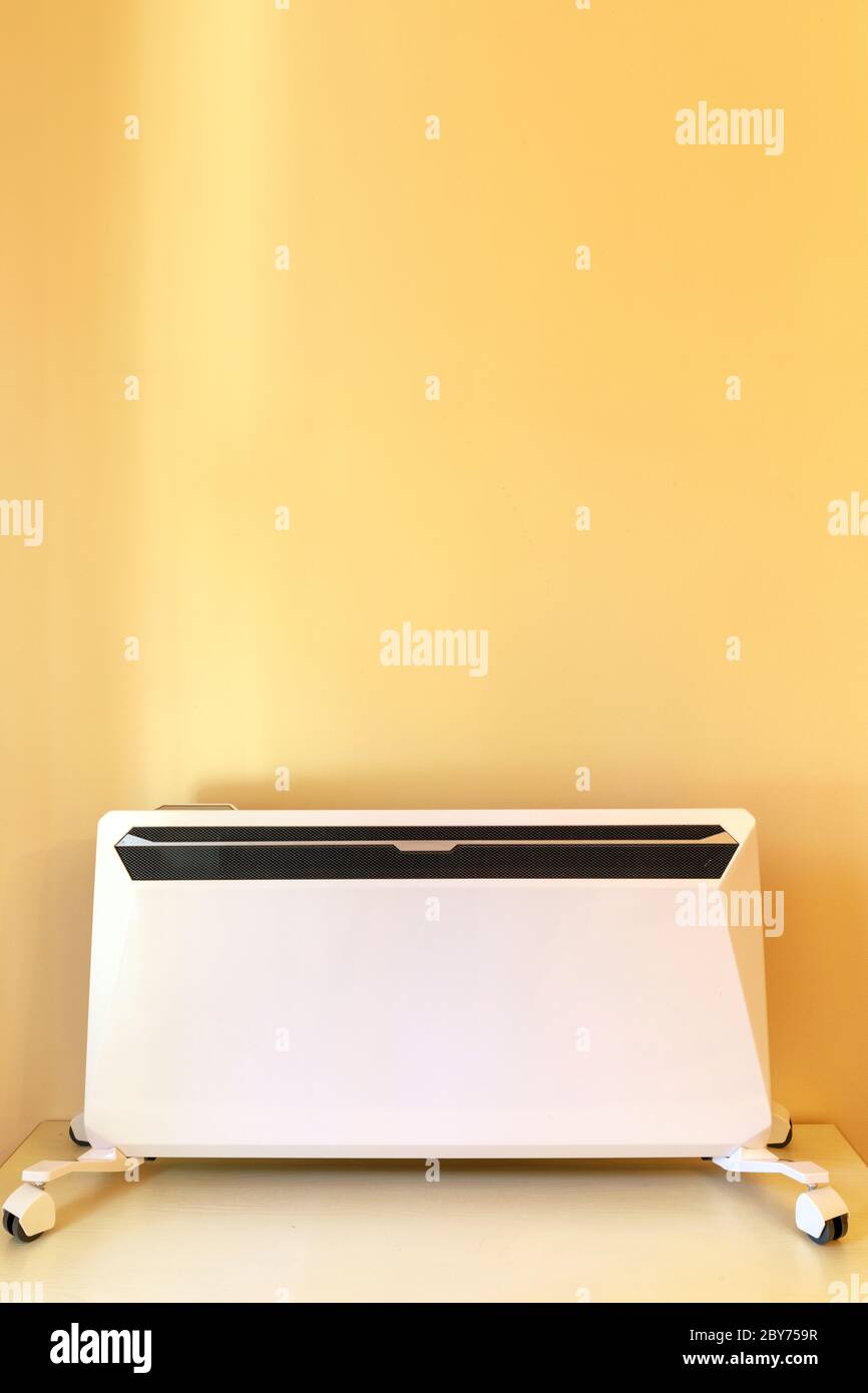 Using heater at home in winter. Heating season. Modern Electric Heater ...
