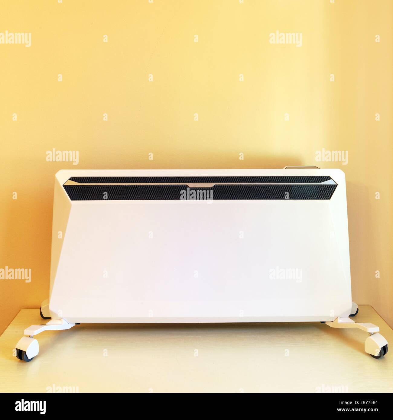 Using heater at home in winter. Heating season. Modern Electric Heater ...