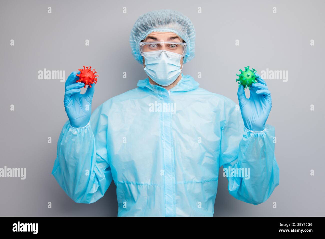 Photo of excited guy expert doc virology center hold two different ...