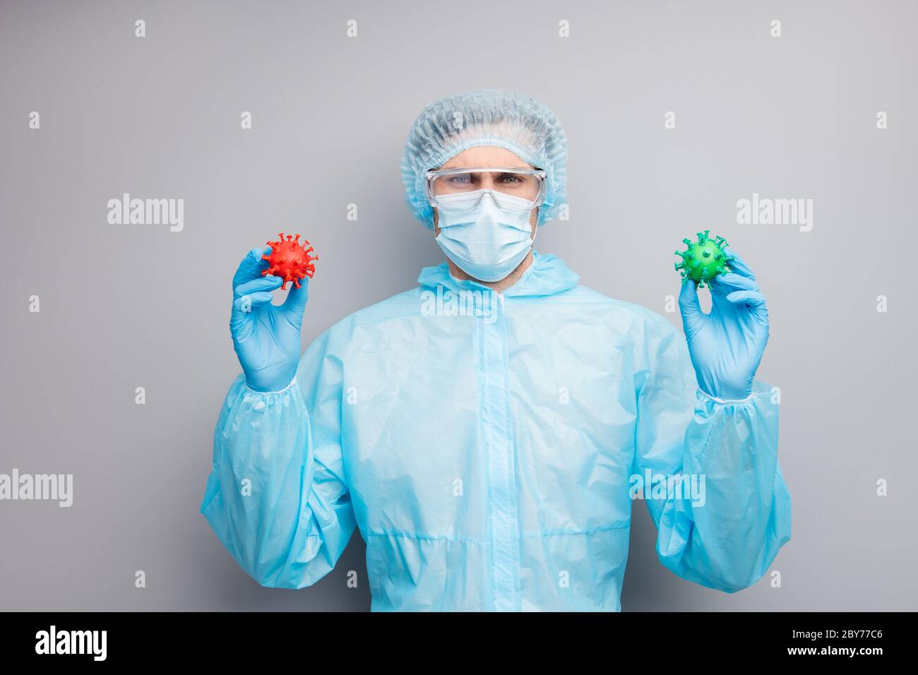 Photo of serious guy expert doc virology center hold two different ...
