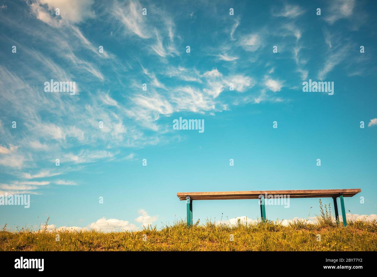 Bench against blue sky with light clouds. Bottom view Stock Photo - Alamy