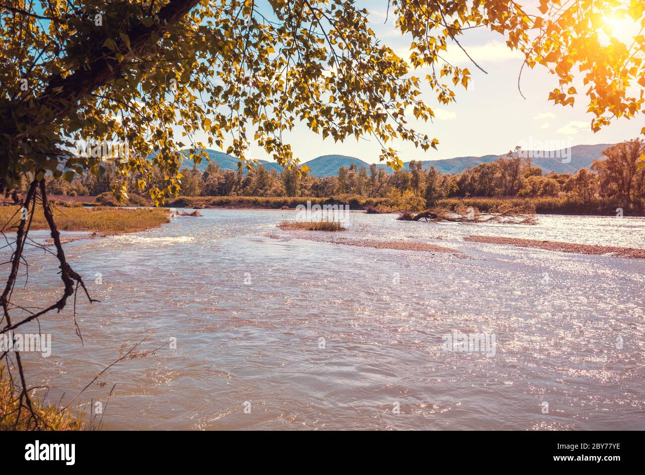 Magical sunset over the river in a mountain valley. River in the ...