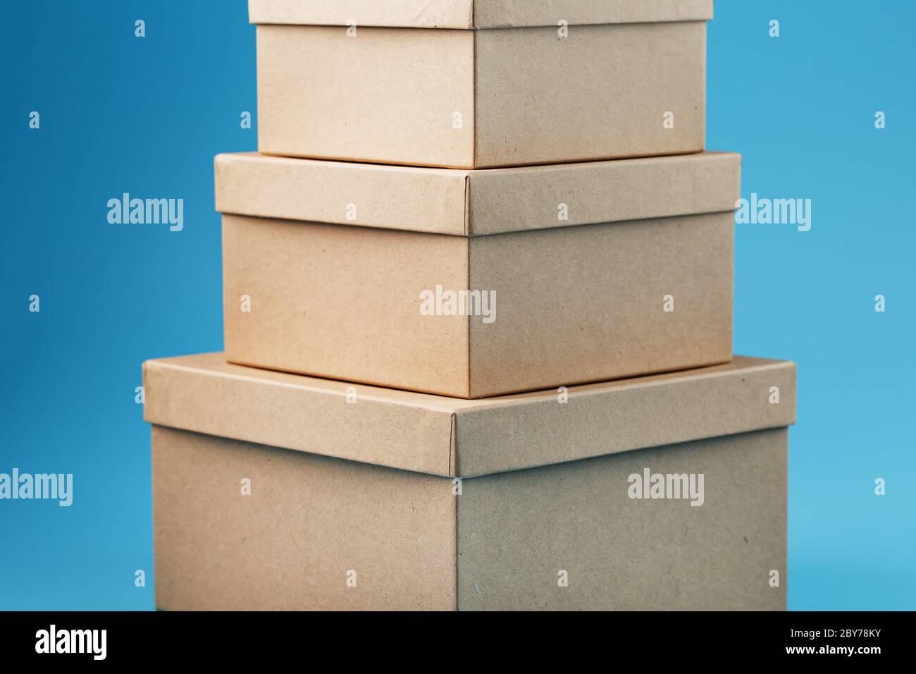 Cardboard boxes in the shape of a pyramid on a blue background Stock ...