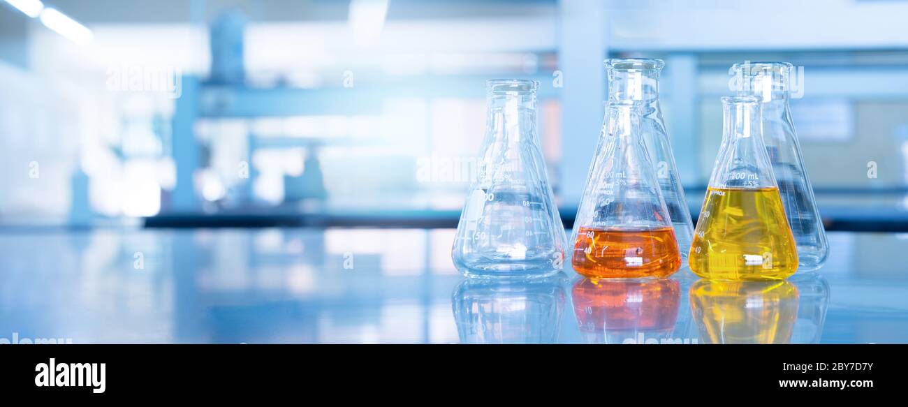 orange yellow solution in science glass flask win blue research ...
