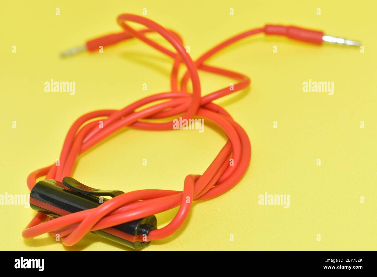 Red color cable in yellow background Stock Photo - Alamy