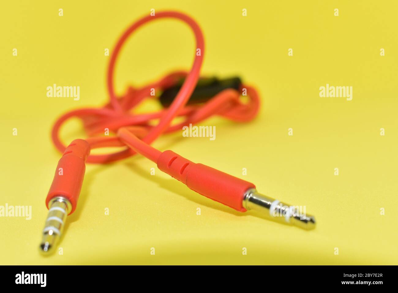 Red color cable in yellow background Stock Photo - Alamy