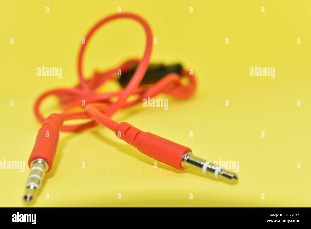 Red color cable in yellow background Stock Photo - Alamy