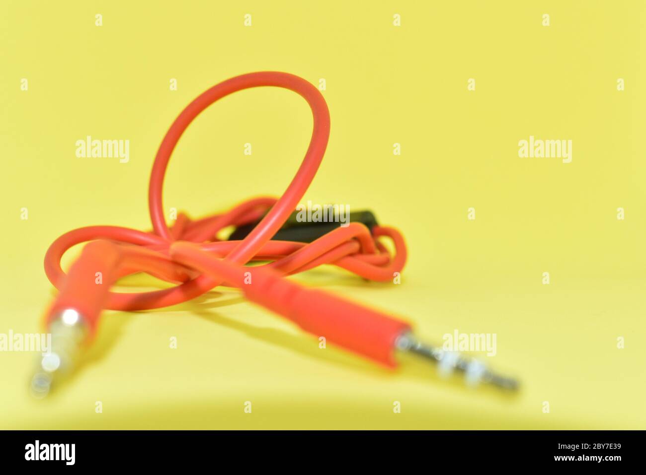 Red color cable in yellow background Stock Photo - Alamy